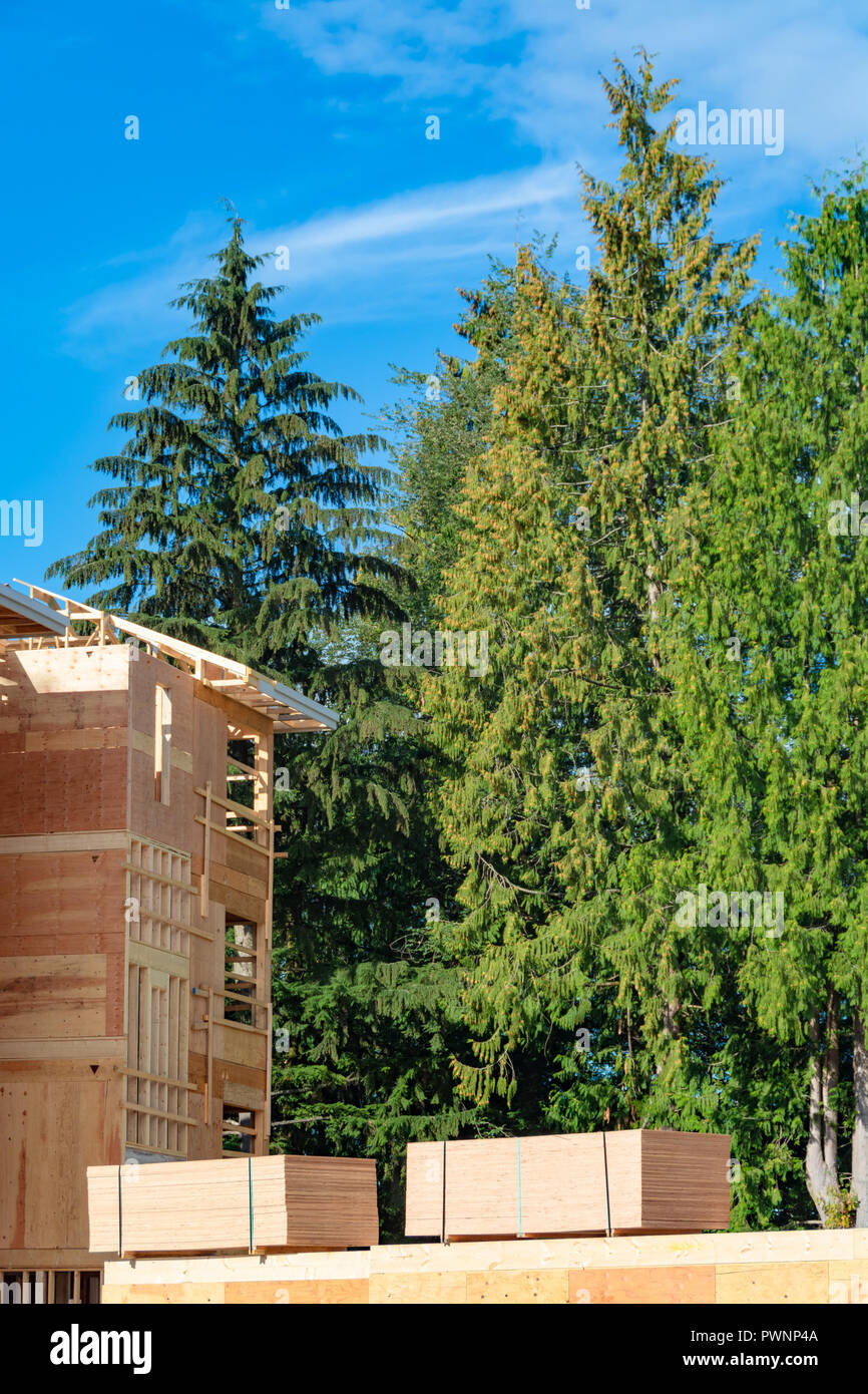 Apartment building under construction with two trunks of timber stored ...
