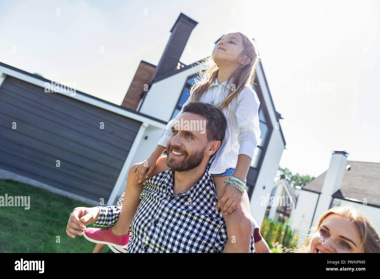 Happy male person keeping his kid on shoulders Stock Photo - Alamy