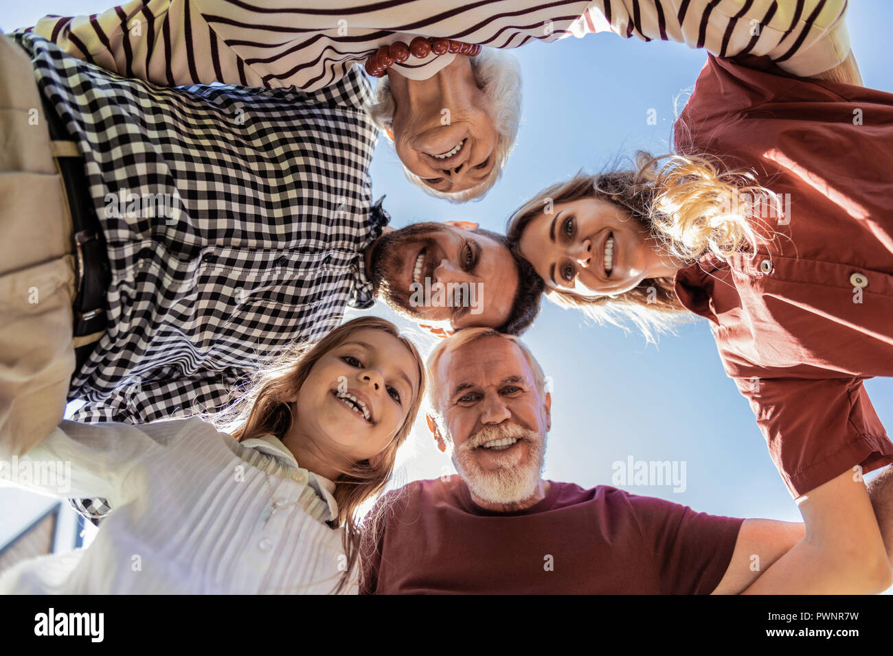 delighted people looking downwards at camera Stock Photo - Alamy
