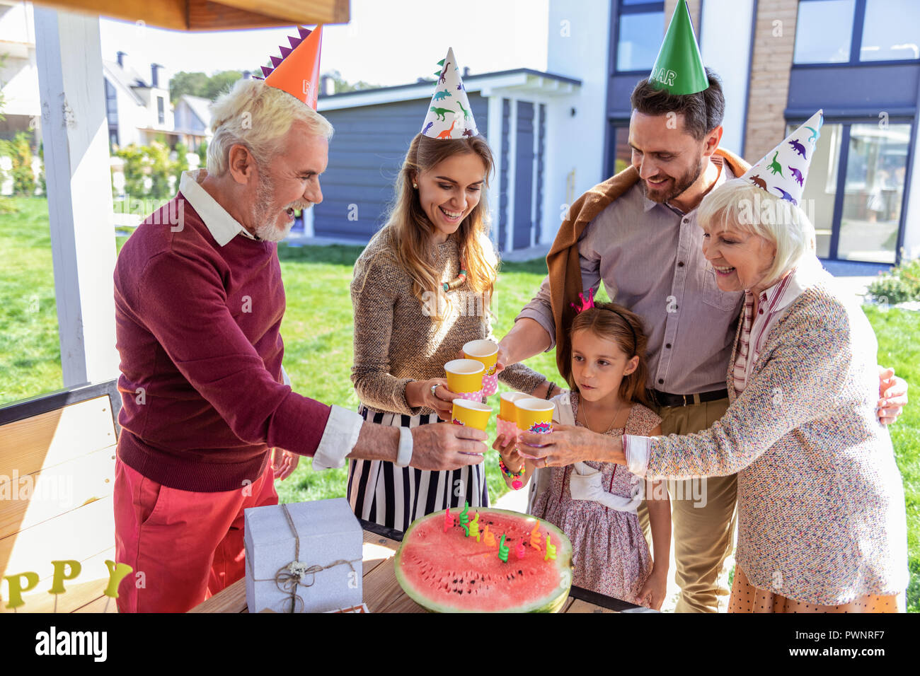 Positive delighted people celebrating birthday of their kid Stock Photo ...