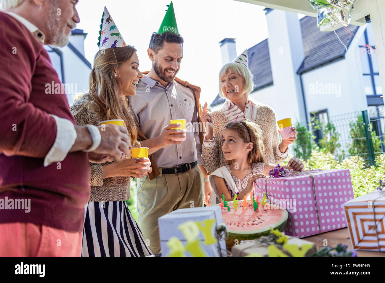 Beautiful birthday girl opening big box with present Stock Photo - Alamy