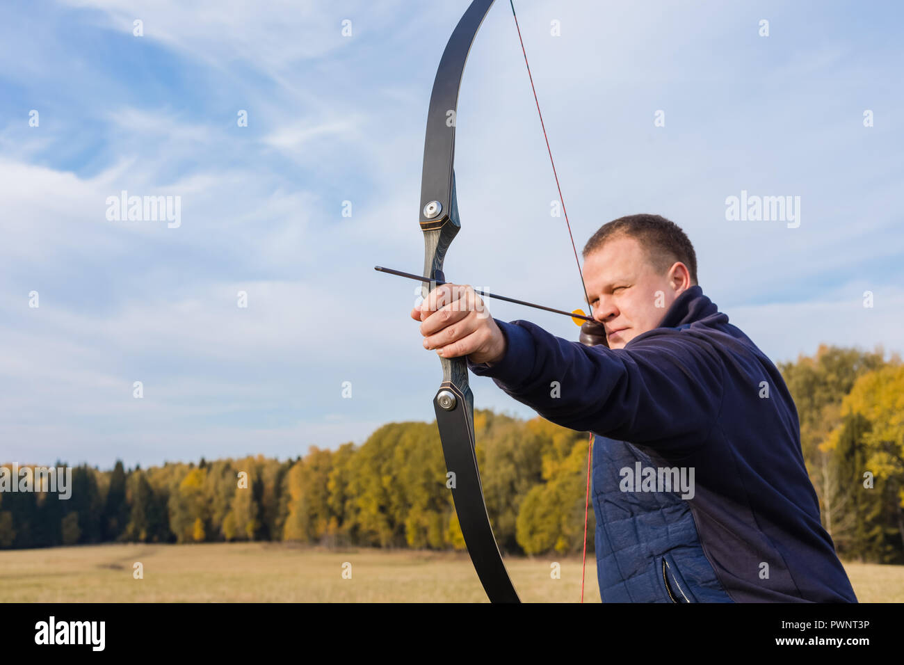 Athlete aiming at a target and shoots an arrow, toned Stock Photo - Alamy