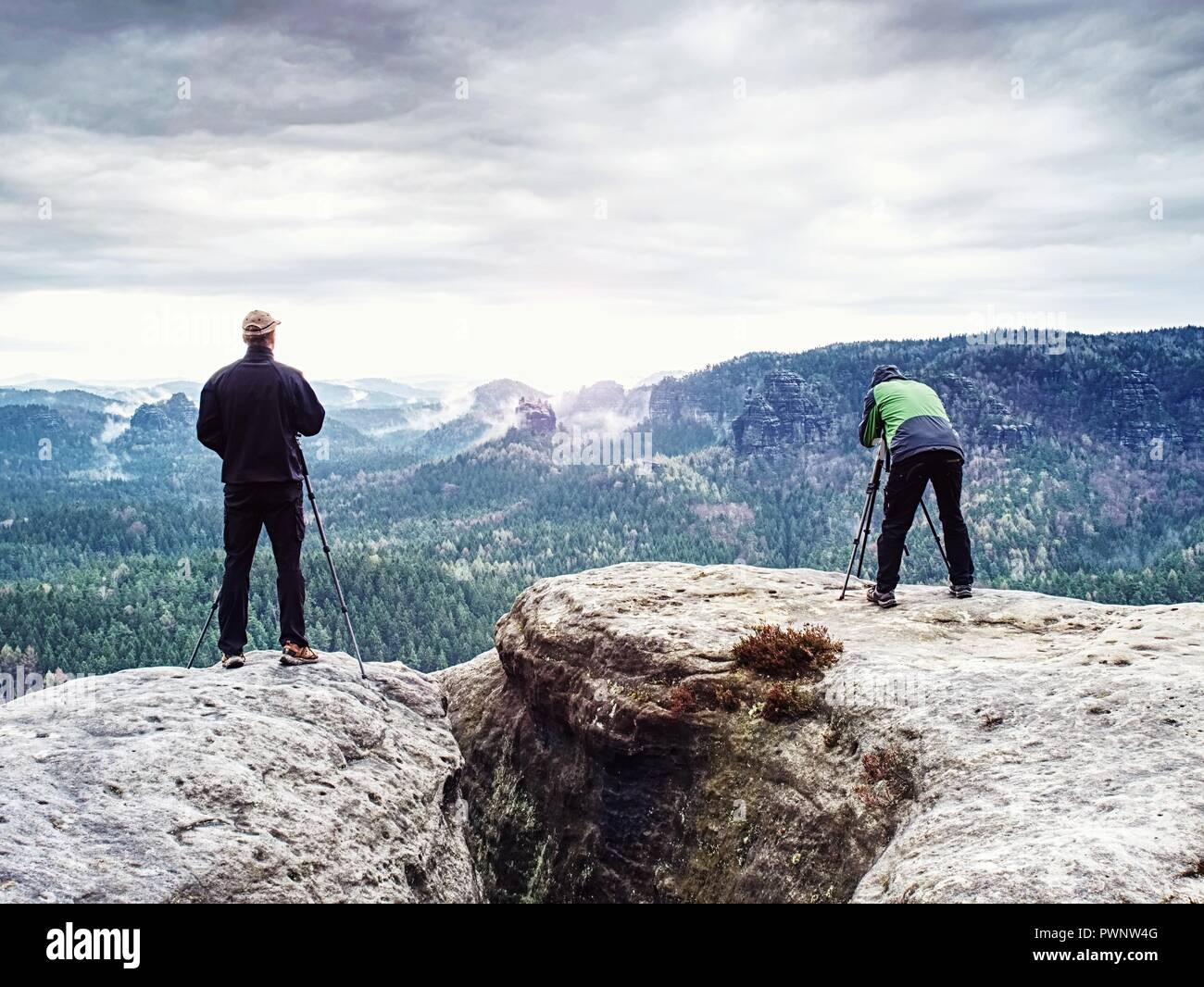 Outdoor shot of talented hobby photographers taking pictures in rocks ...