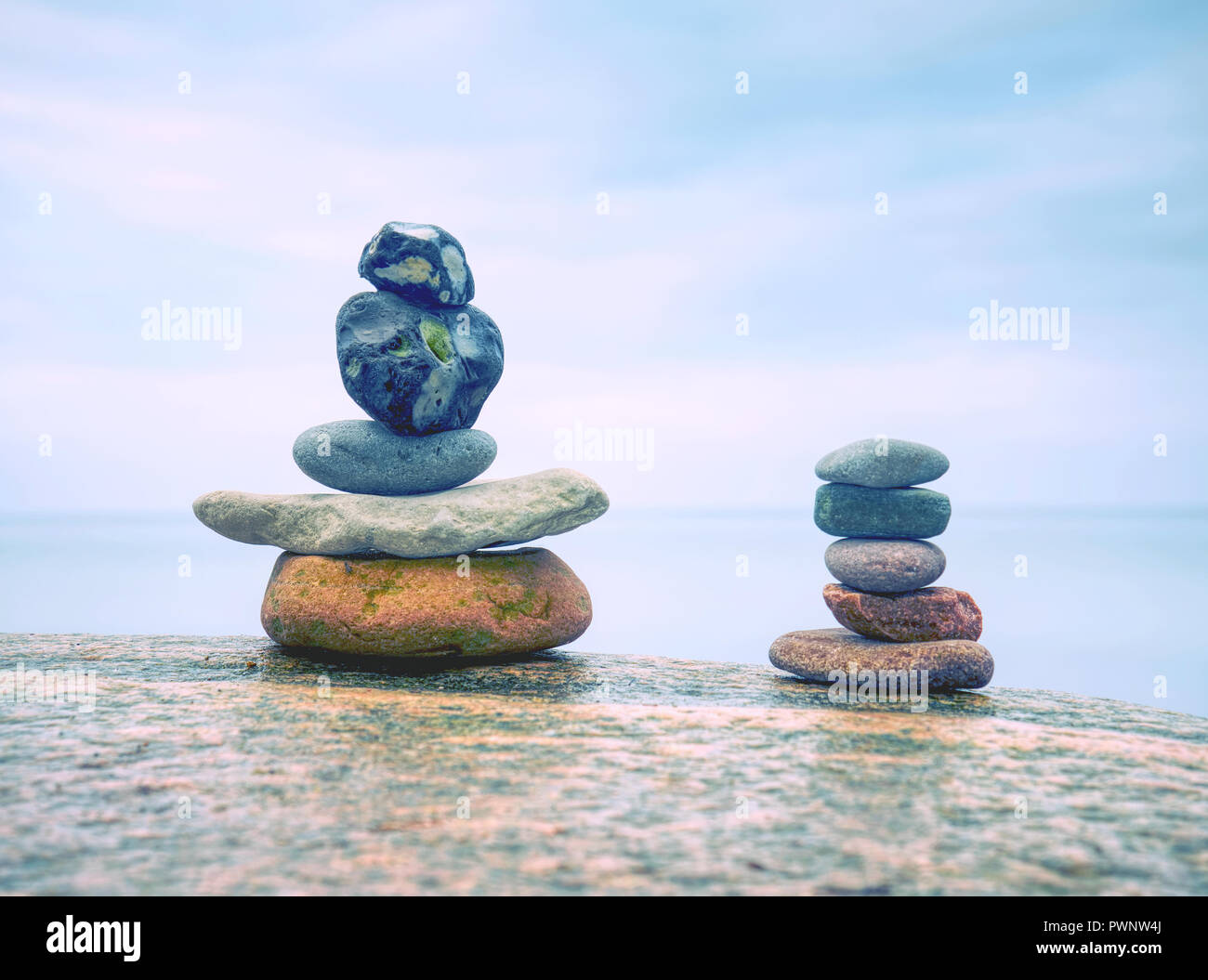 Stack of stones on the sea beach. Rounded pebbles stack in peaceful ...