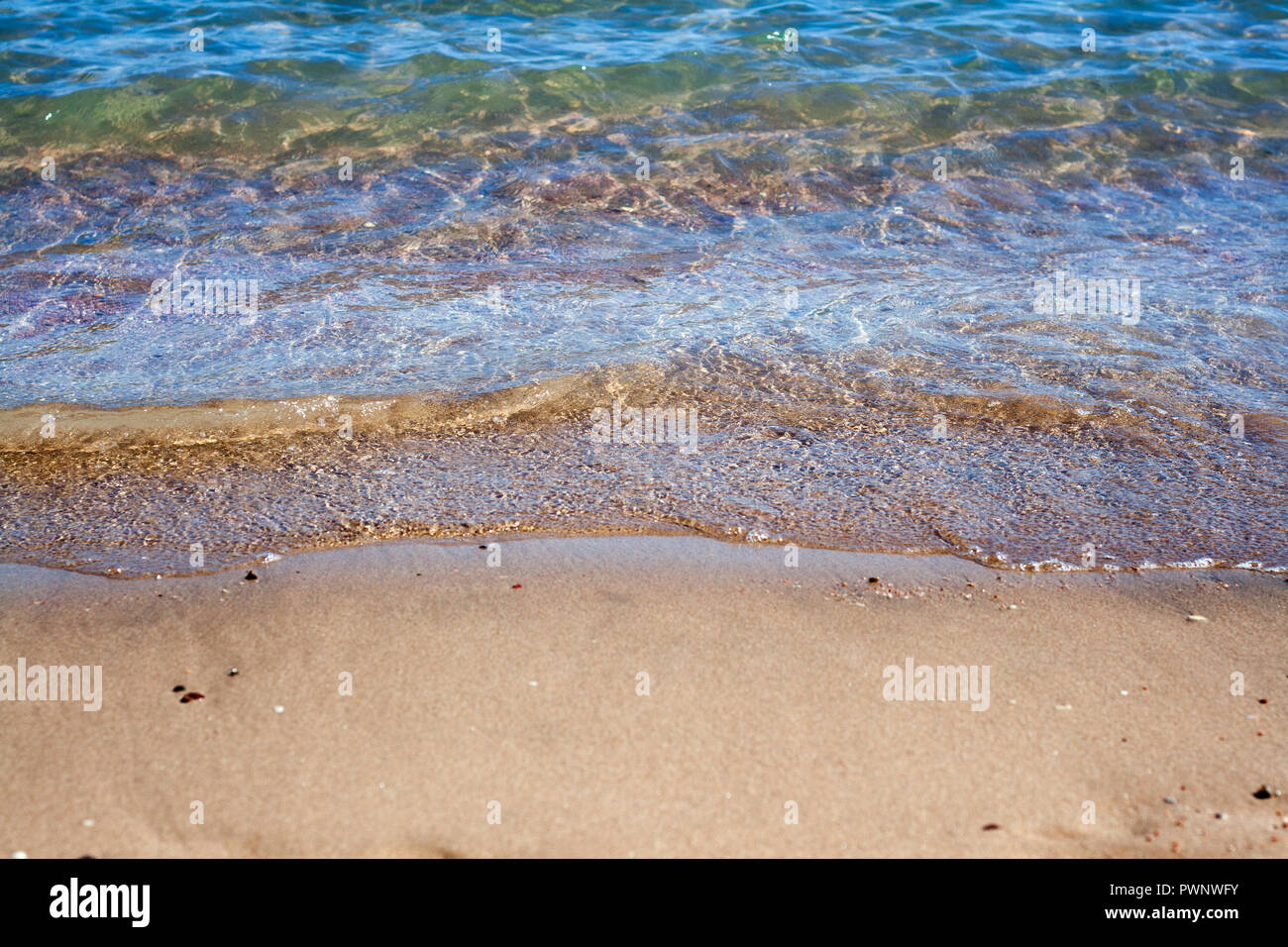 Transparent waves roll on sandy hi-res stock photography and images - Alamy