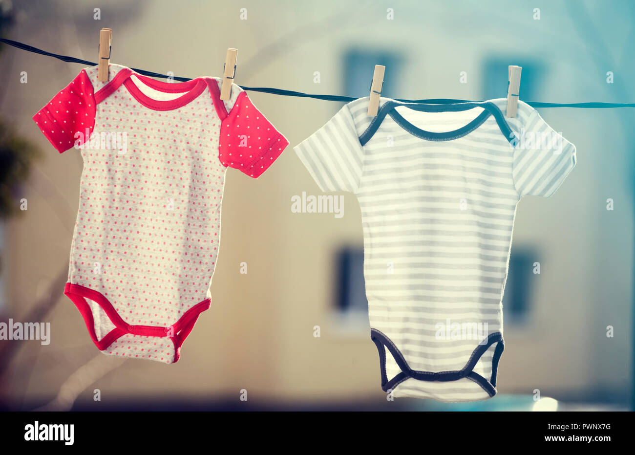 Baby clothes hanging on the clothesline Stock Photo - Alamy
