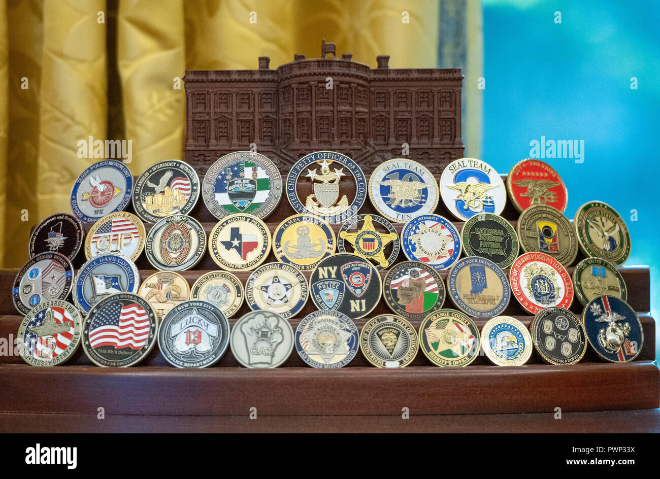 Military challenge coins displayed on the credenza behind the desk of ...