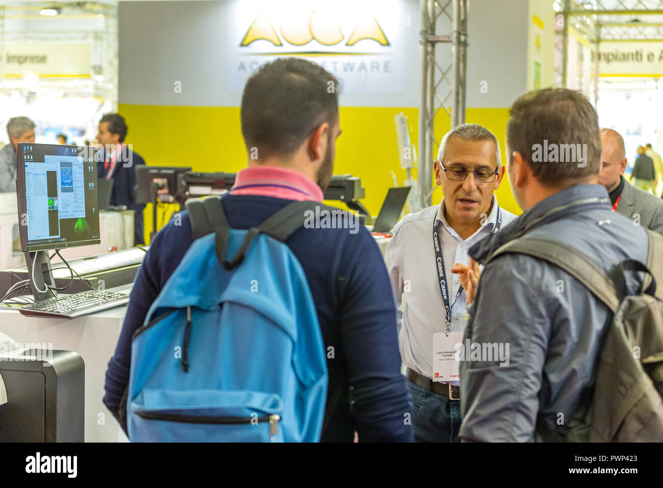 Bologna, Italy. 17th October, 2018. Booth presenter welcomes visitors ...