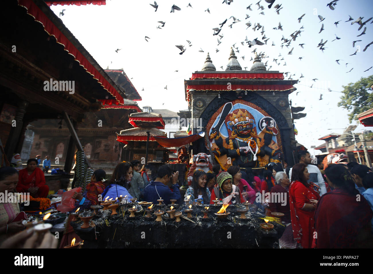 Kathmandu, Nepal. 18th Oct, 2018. Nepalese devotees light butter lamps ...