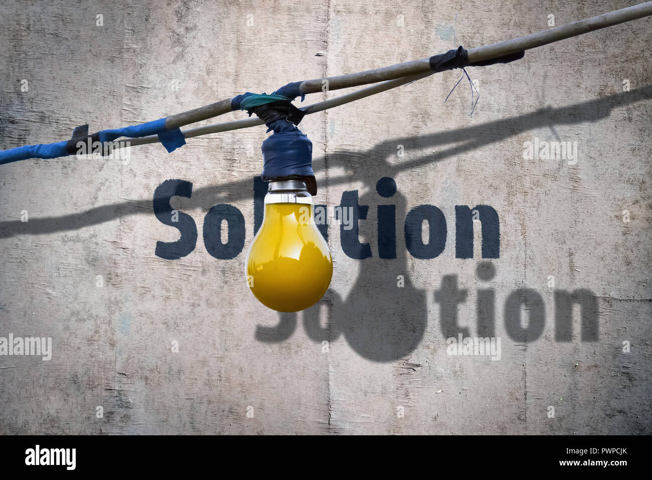Yellow electric bulb and word Solution written under it Stock Photo - Alamy