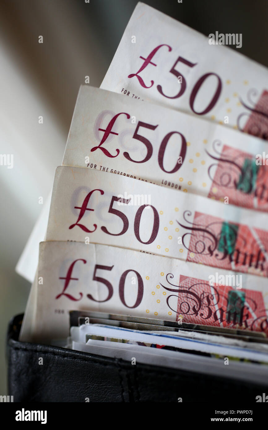 A selection of £50 notes along with £10 and £5 notes in a wallet in ...