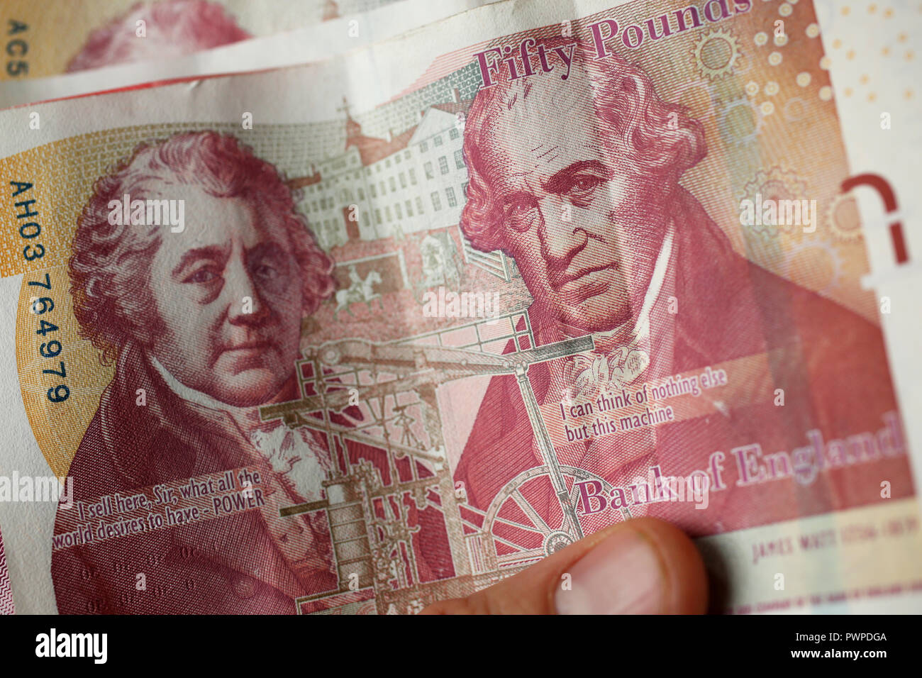 A selection of £50 notes along with £10 and £5 notes in a wallet in ...