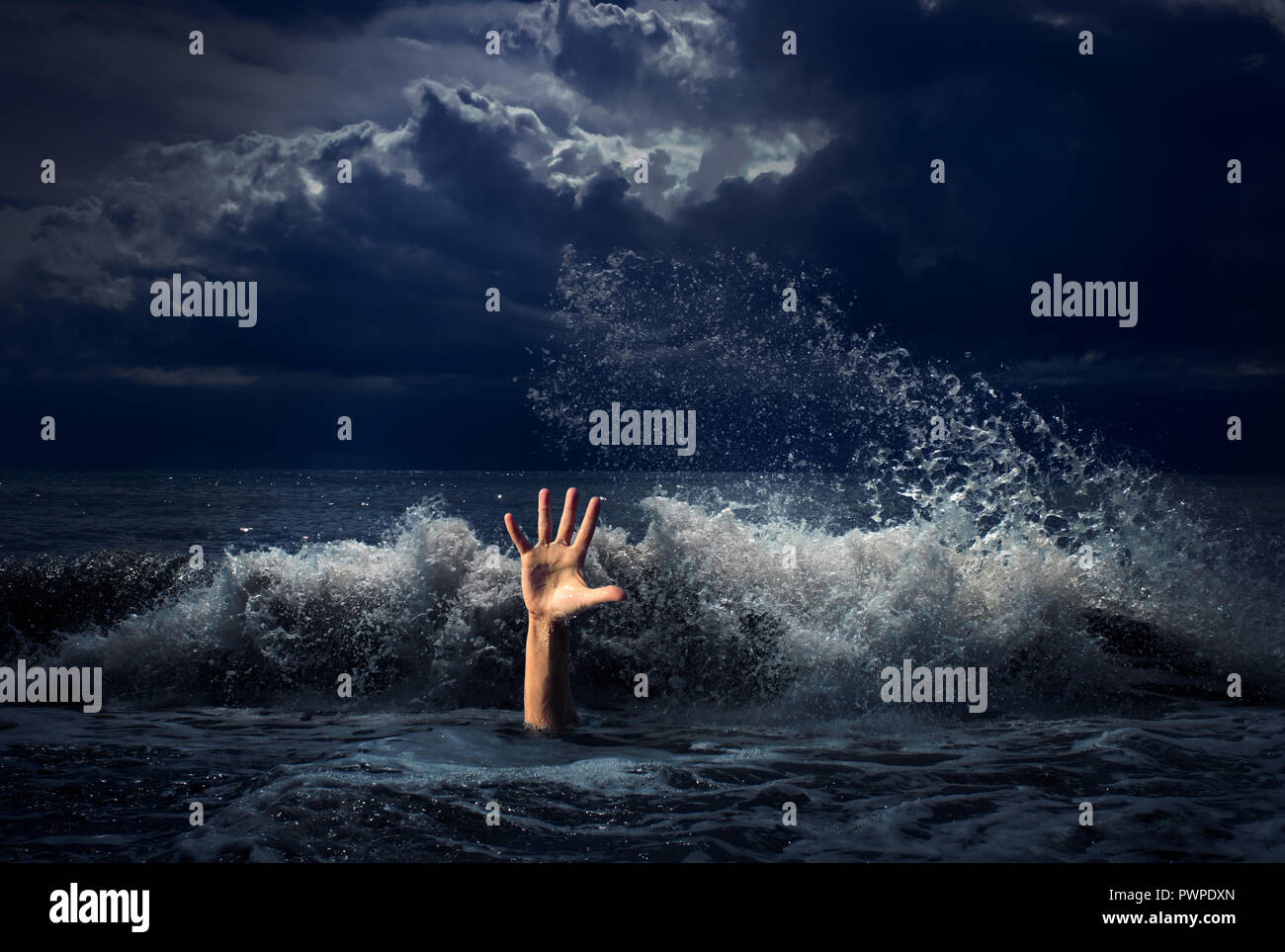 drowning man hand in storm sea water Stock Photo - Alamy