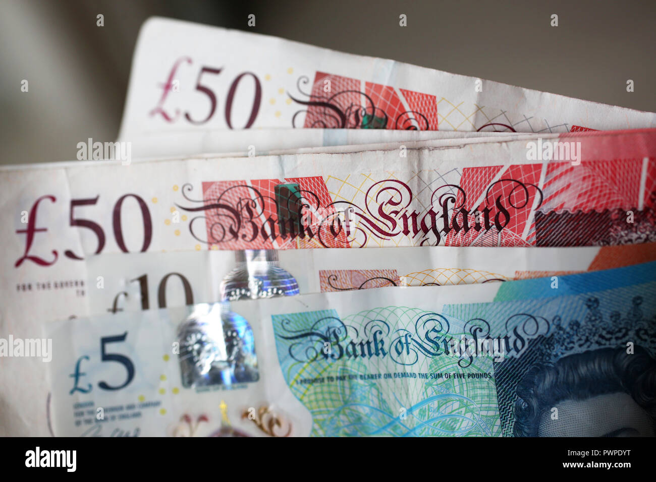 A selection of £50 notes along with £10 and £5 notes in a wallet in ...
