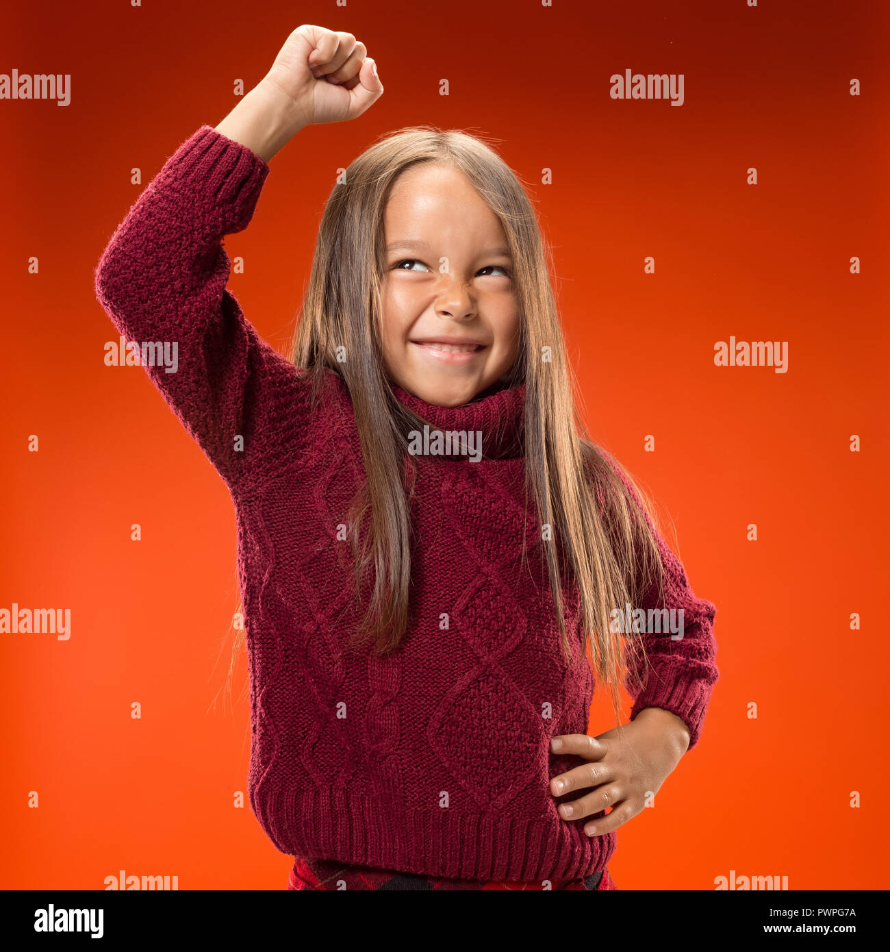 Angry teen girl standing on trendy studio background. Female half ...