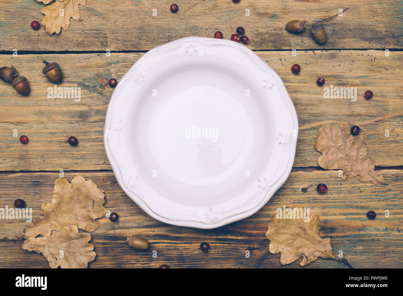 Thanksgiving dinner concept background: white plate, spoon and fork on ...