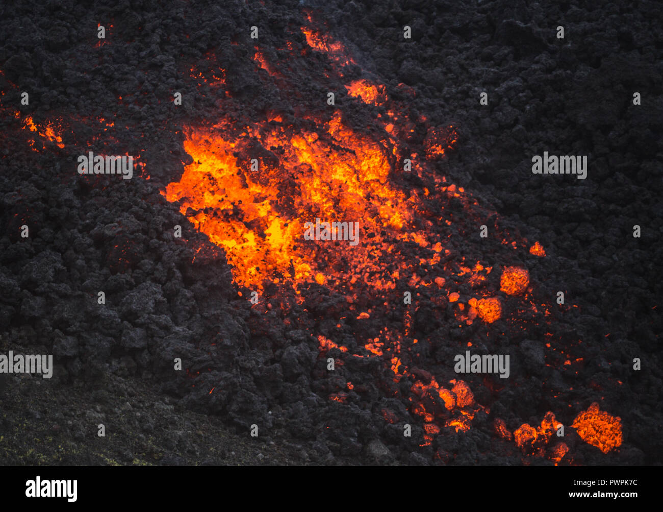Red hot volcanic rock rolls down the side of the active Pacaya volcano ...