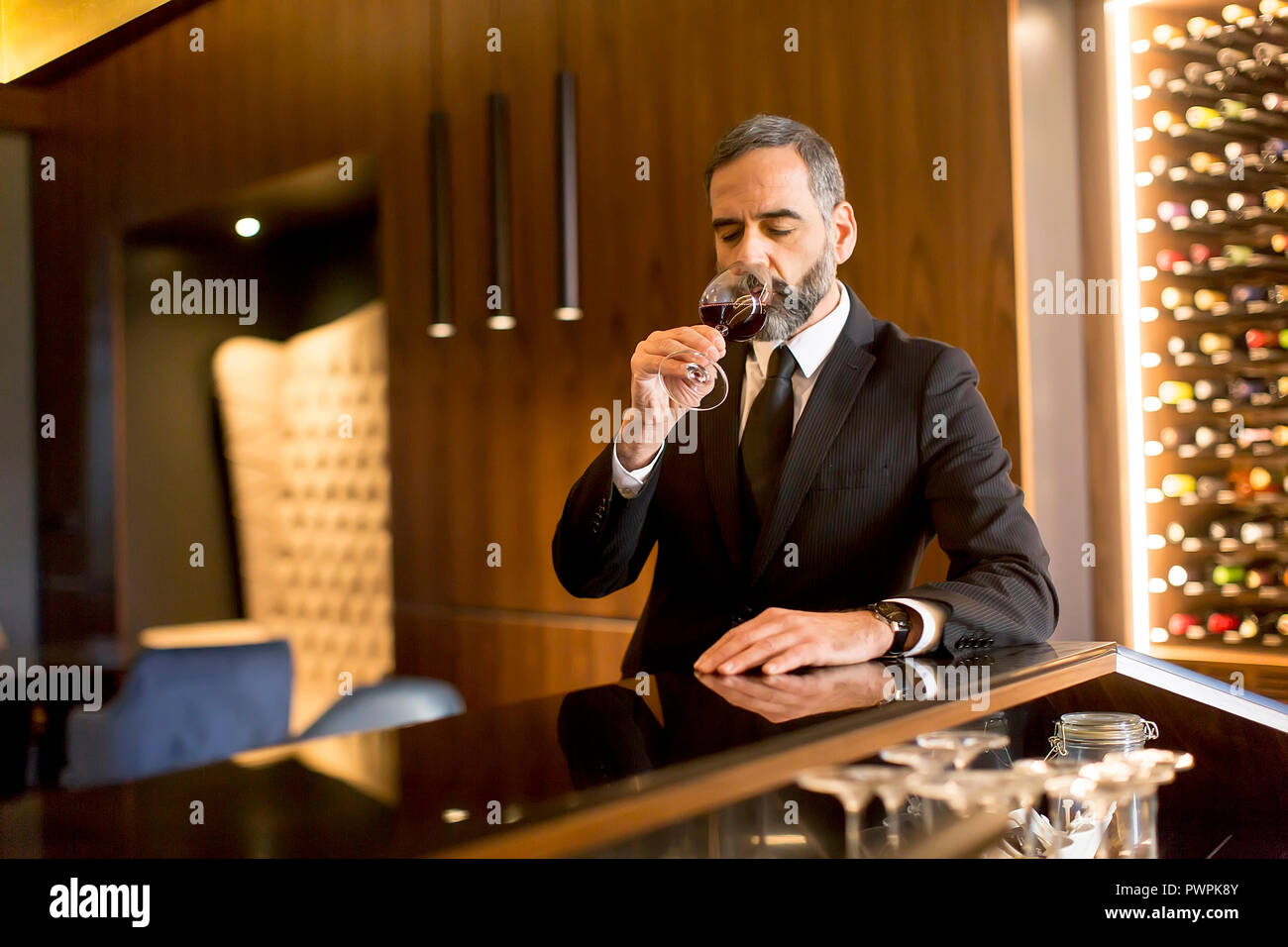 Portrait of senior handsome man drinking red wine Stock Photo - Alamy