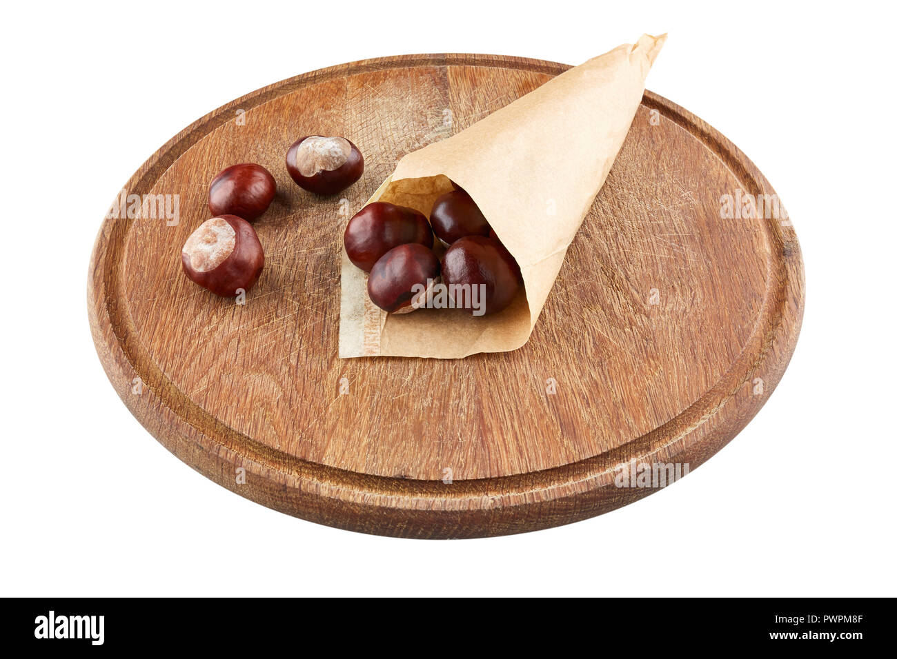 Chestnuts in paper package on wooden plate. Isolated on white ...