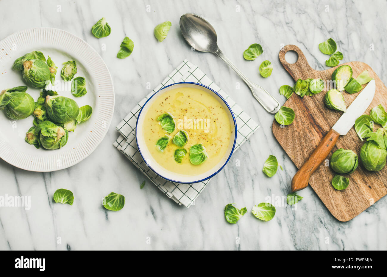 Flat-lay of seasonal brussels sprouts vegetable cream soup in bowl and ...
