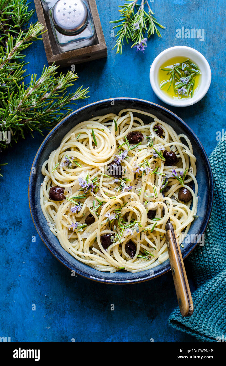 Spaghetti with onions rosemary and black olives Stock Photo - Alamy