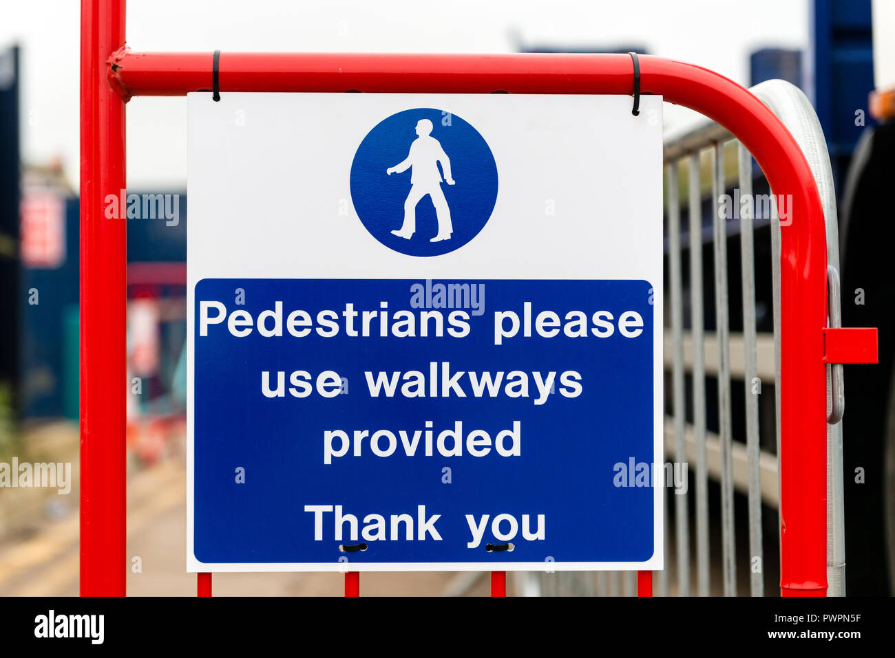 Pedestrians please use walkways provided sign Stock Photo - Alamy