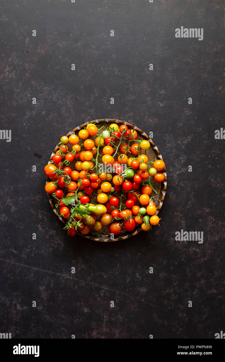 Tomatoes on a black background Stock Photo - Alamy