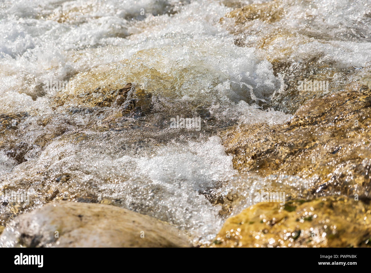Water bubbling between rocks in mountain stream Stock Photo - Alamy