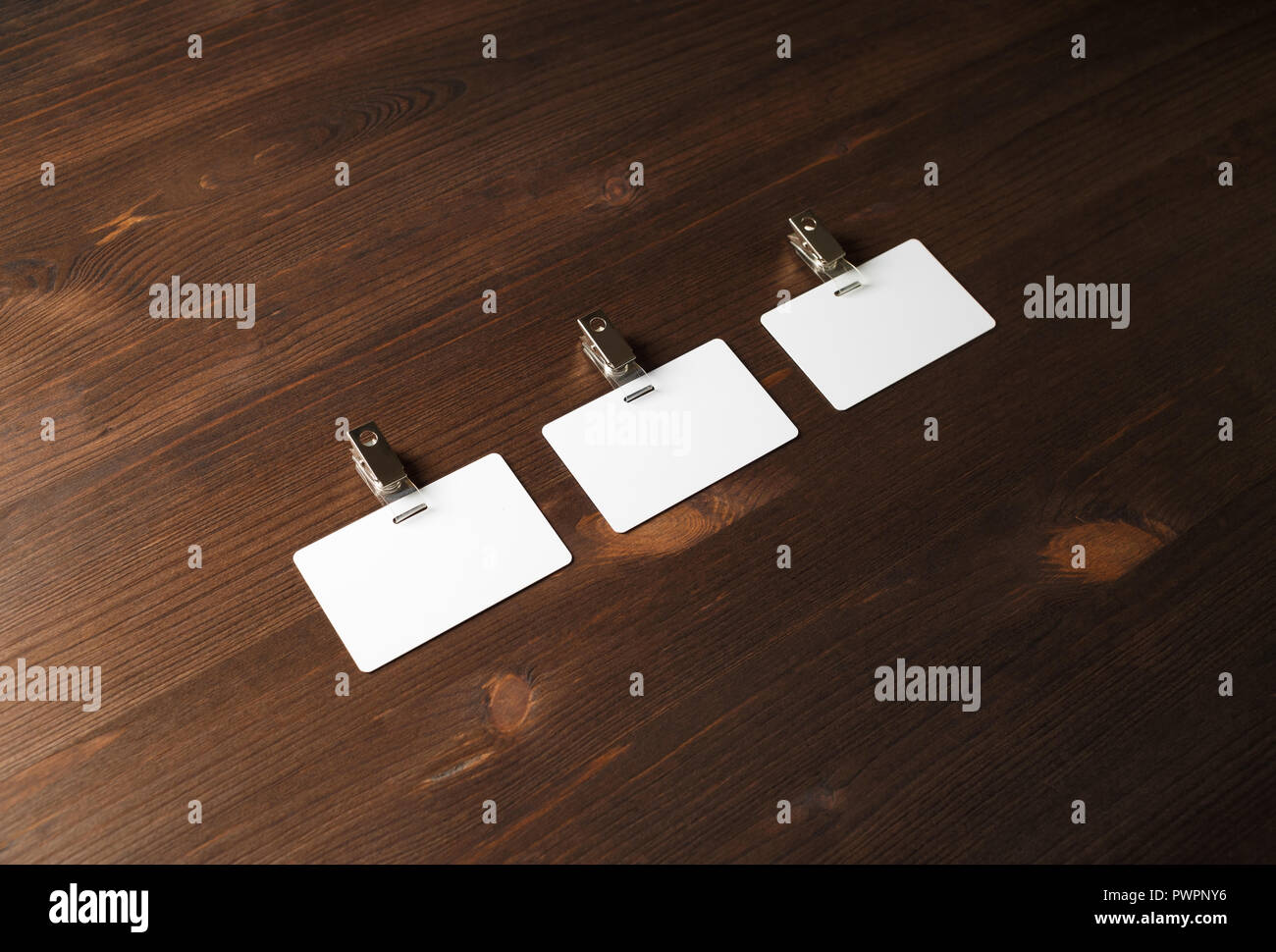 Three blank white badges on wood table backgroun. Space for text Stock ...