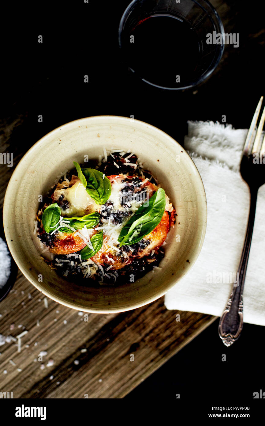 Caprese Black Rice Casserole served in a ceramic bowl. Photographed on ...