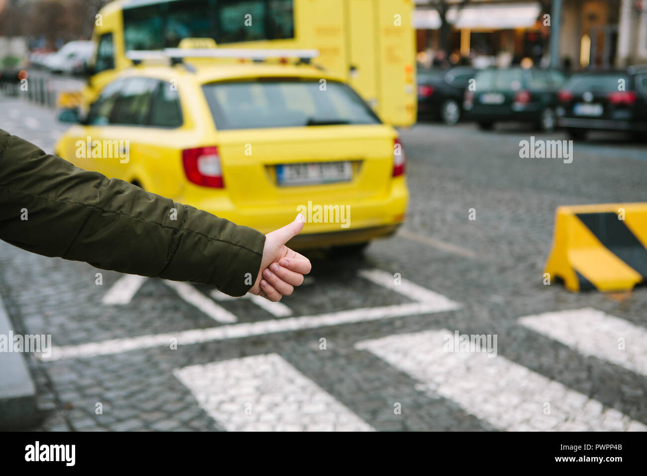 Tourist raised his finger up and trying to catch a taxi on a city ...