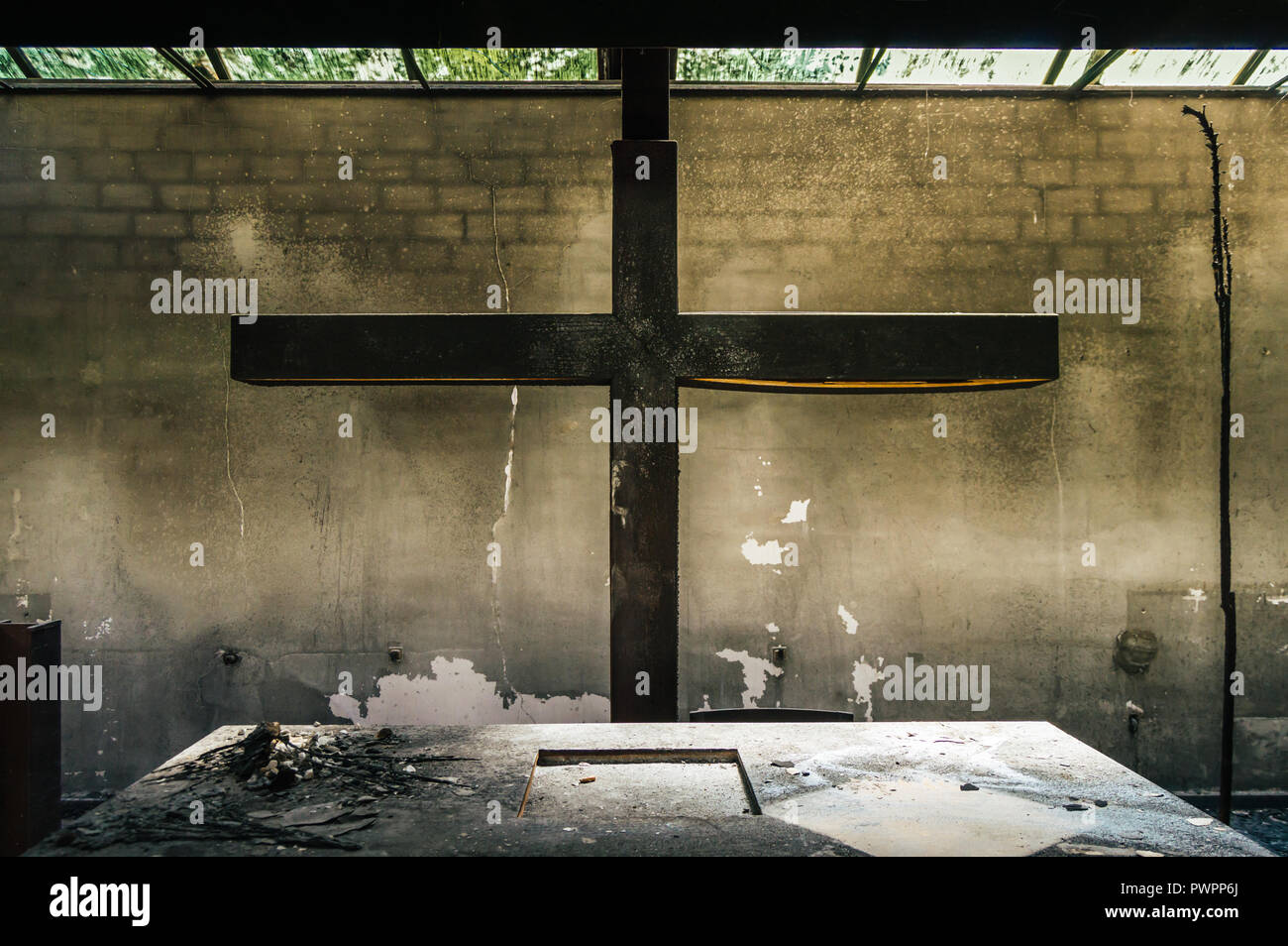 Altar and huge cross in a church or chapel destroyed by fire of a ...