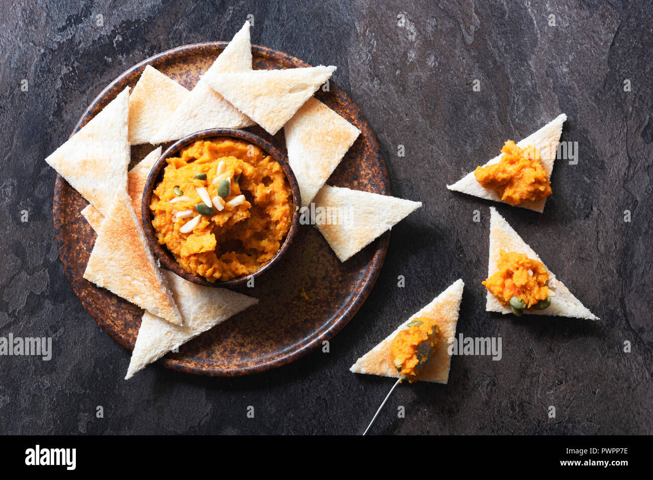 Roasted pumpkin dip spooned onto toast triangles Stock Photo - Alamy