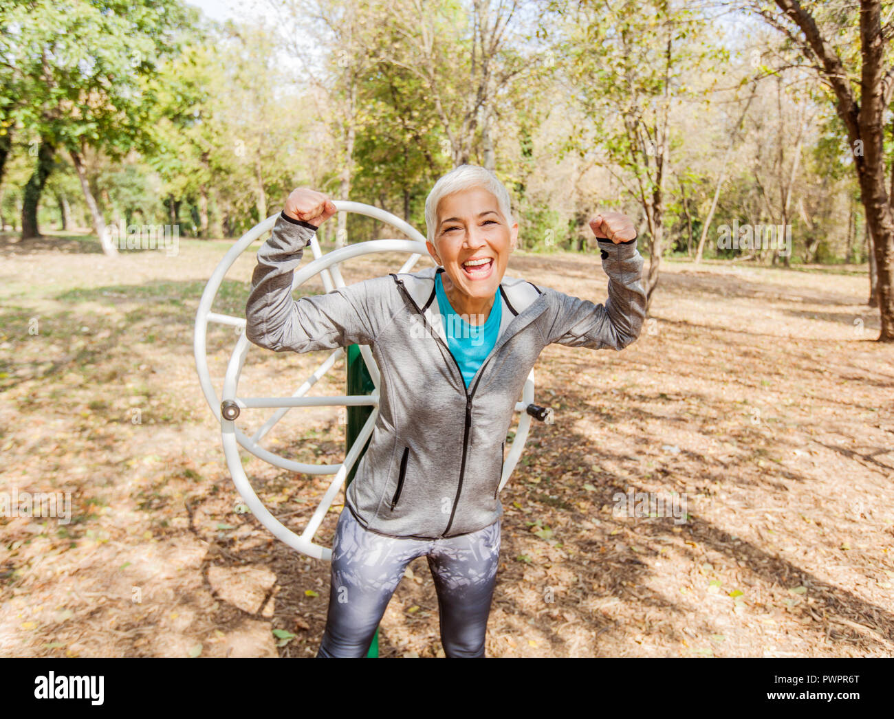 Happy Fit Successful Senior Woman Raised Arms At Outdoor Gym. Shows ...