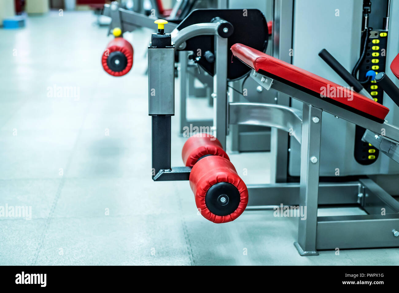 New fitness machines in modern gym interior Stock Photo - Alamy