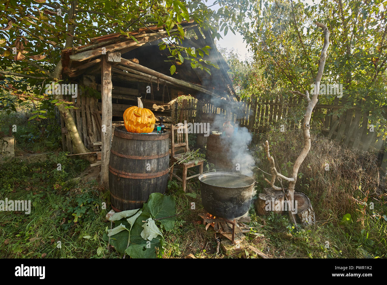 Witch lair with boiling cast iron pot by the shack Stock Photo - Alamy