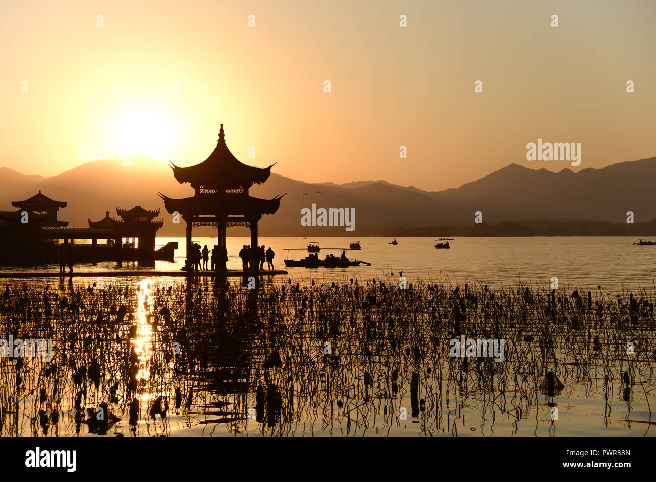 Chinese temple in west lake with sunset Stock Photo - Alamy