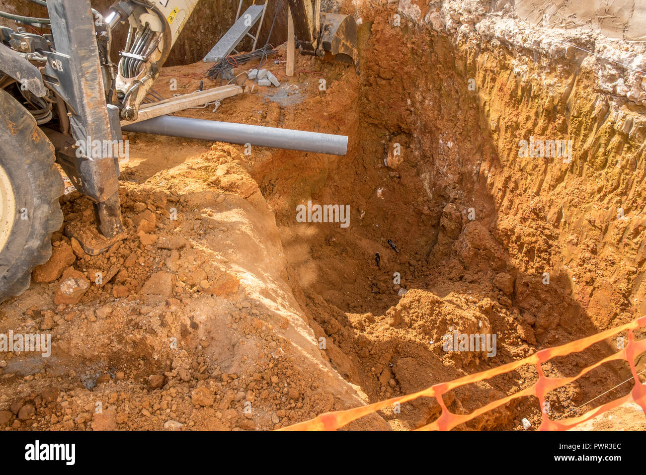 Small building site with a deep trench for foundations with excavating ...