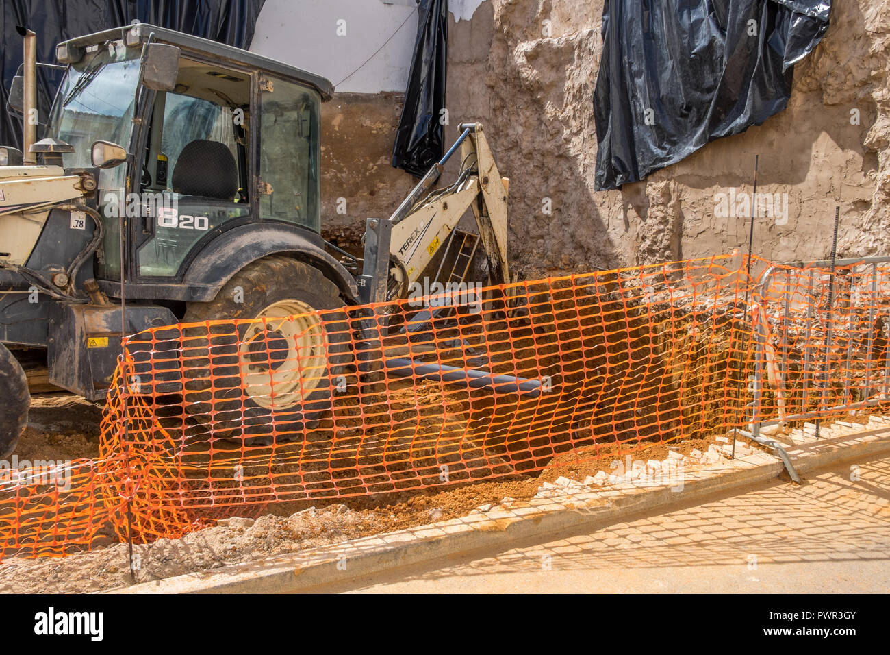 Small building site with a deep trench for foundations with excavating ...