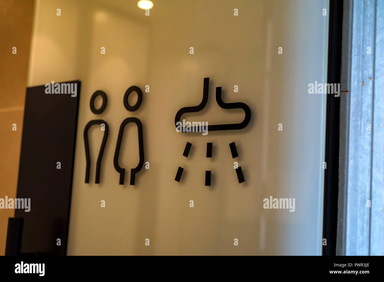 Toilet and shower room signs on wall Stock Photo - Alamy