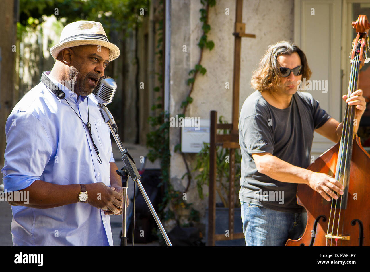 Two musicians performing on street in French village Stock Photo - Alamy