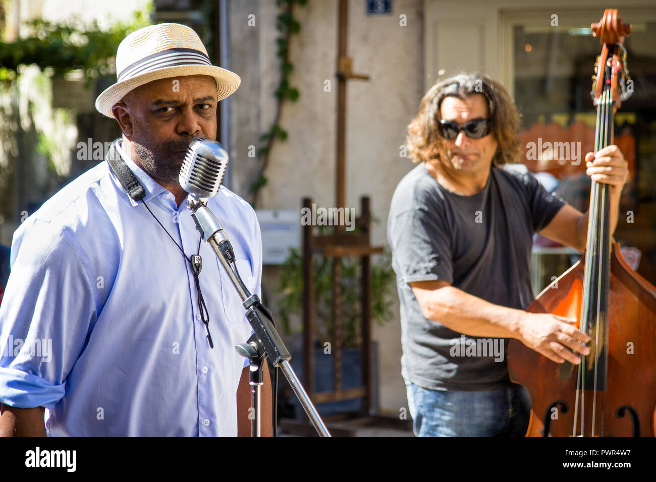 Two musicians performing on street in French village Stock Photo - Alamy