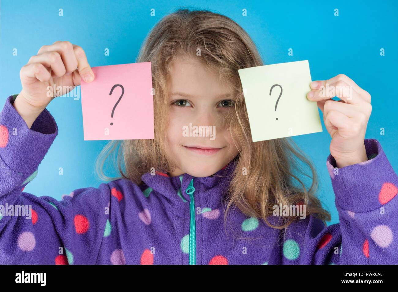 Girl holding sign question mark hi-res stock photography and images - Alamy