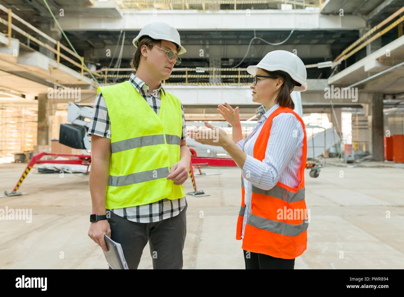 Woman architect and man builder at a construction site. Building ...