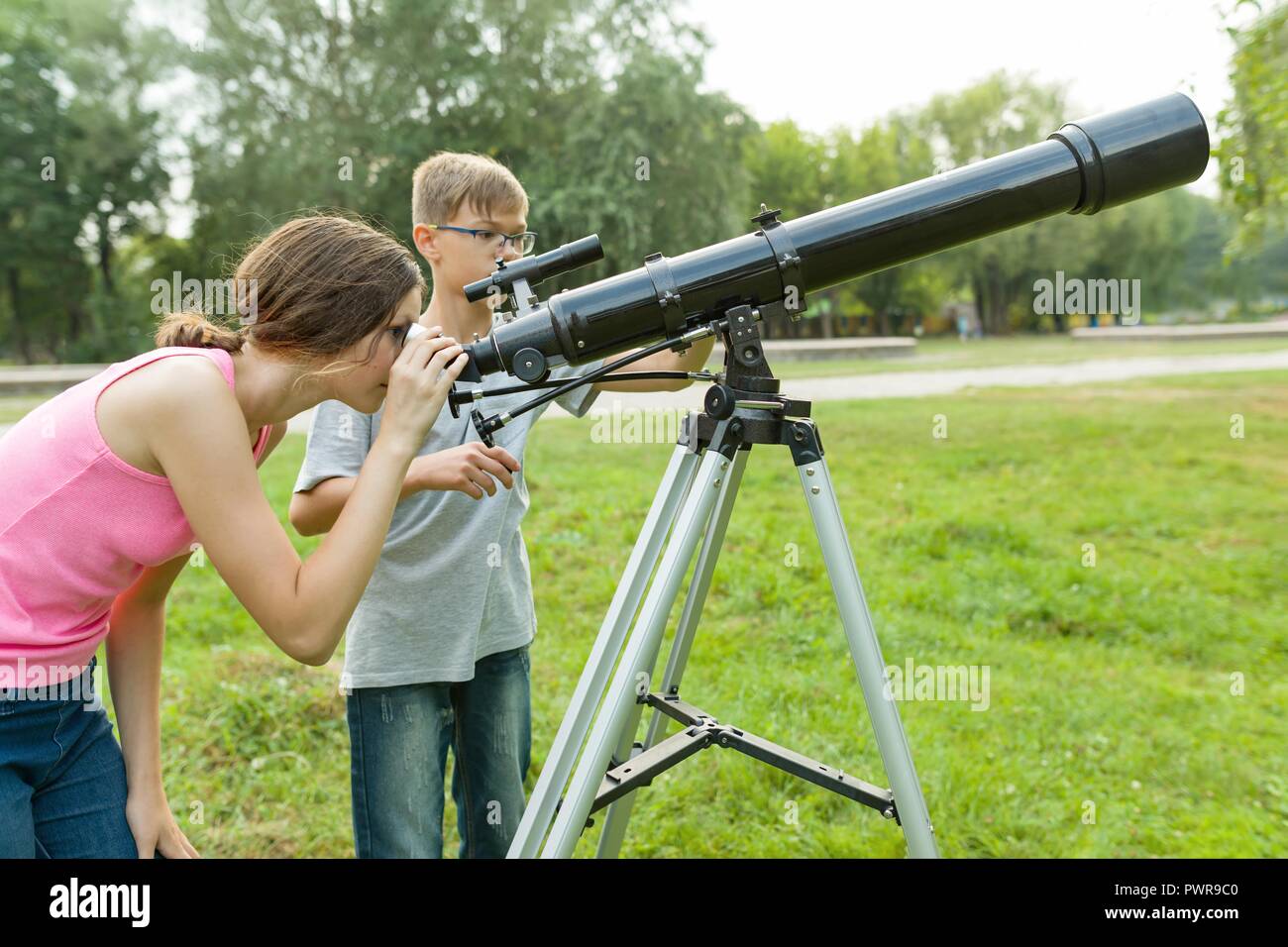 Children teenagers with telescope look at the sky in nature Stock Photo ...