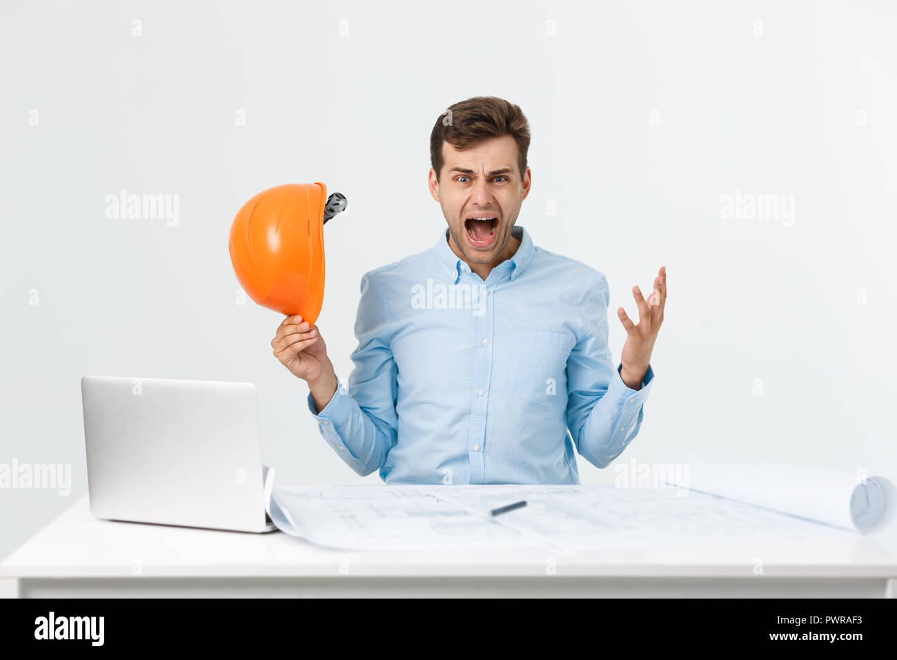 Young workman annoyed angry in furious gesture. Negative expression on ...