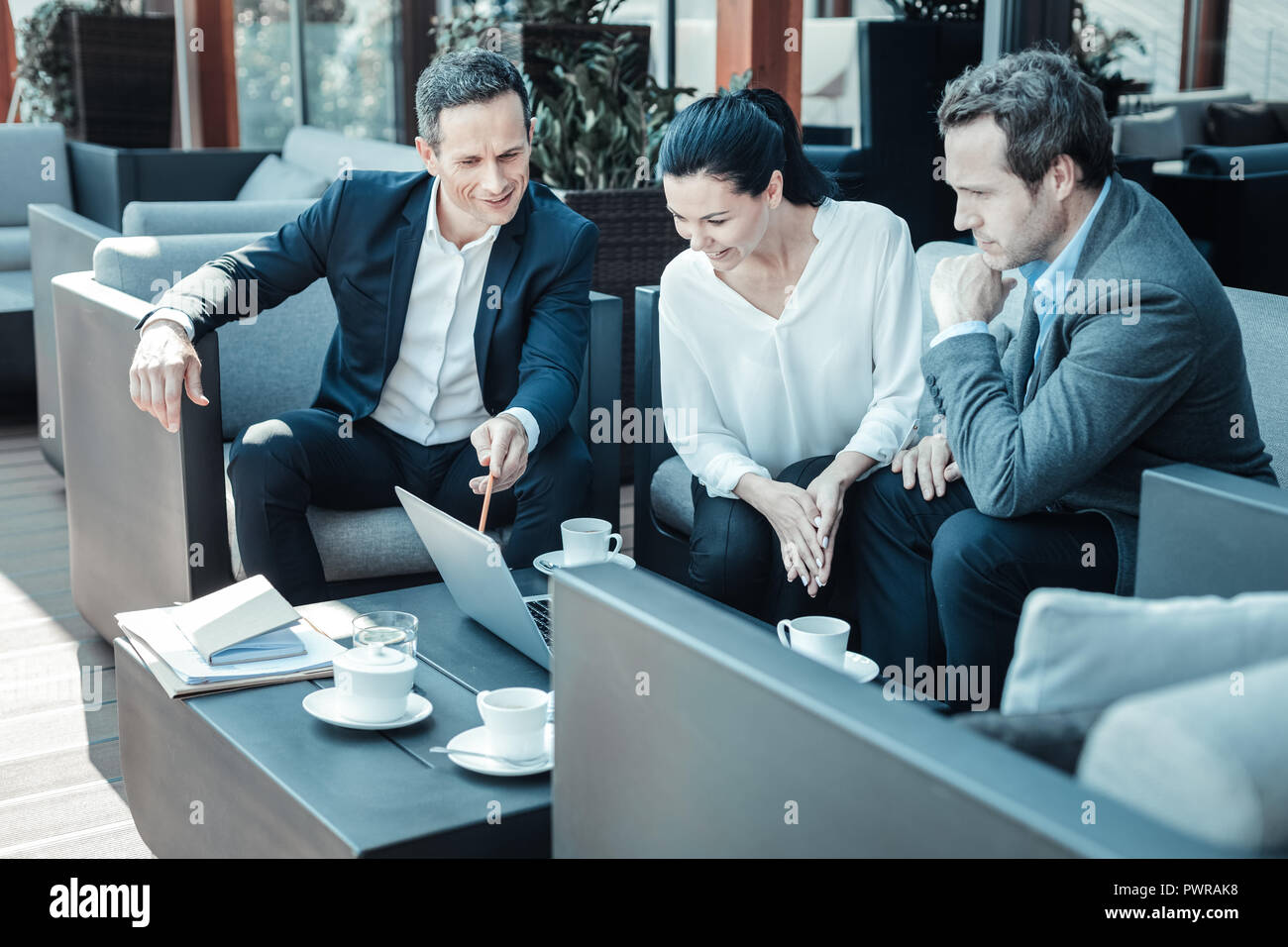 Positive delighted colleagues talking hi-res stock photography and ...