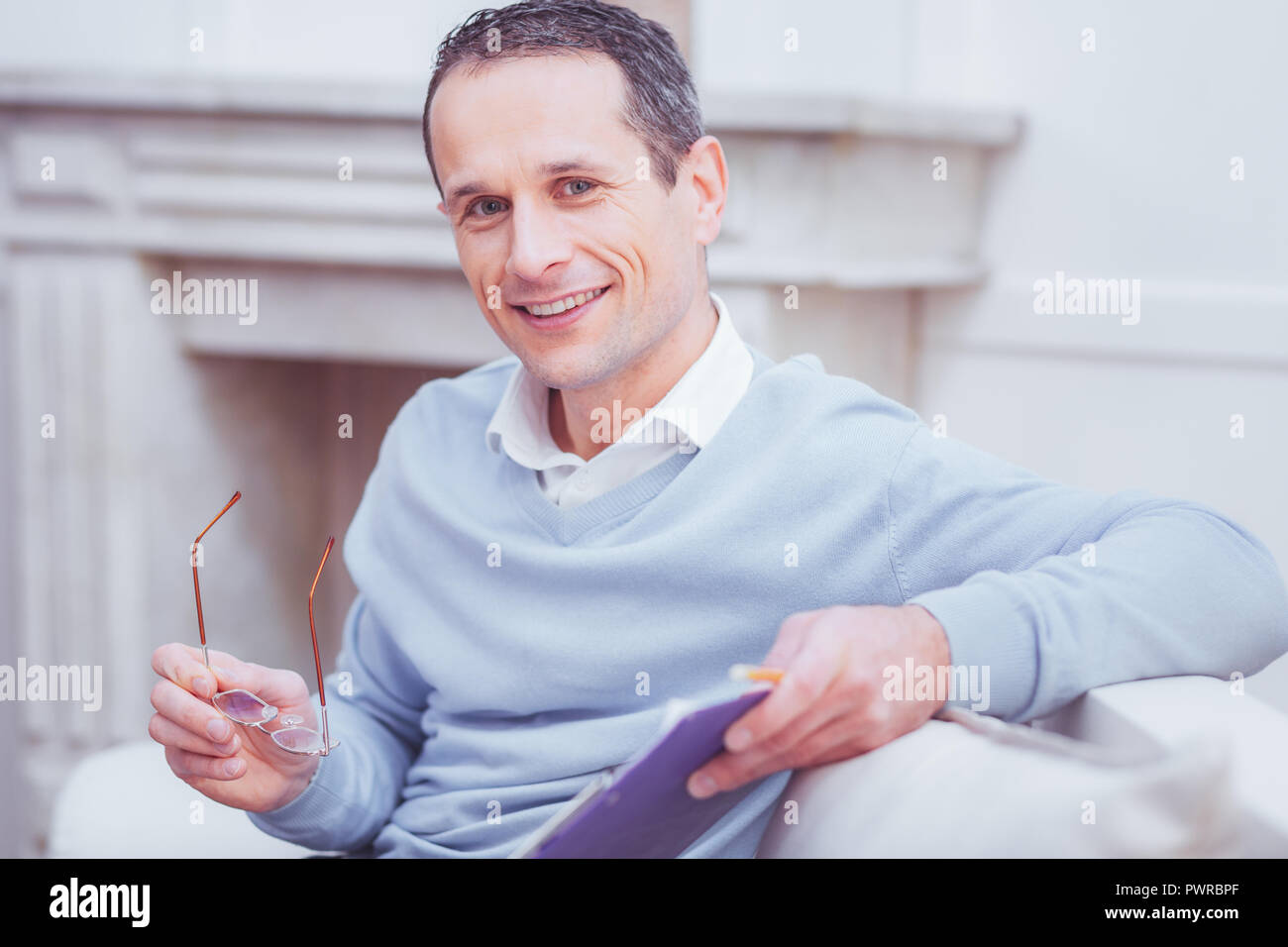 Portrait of optimistic manager with a clipboard Stock Photo - Alamy