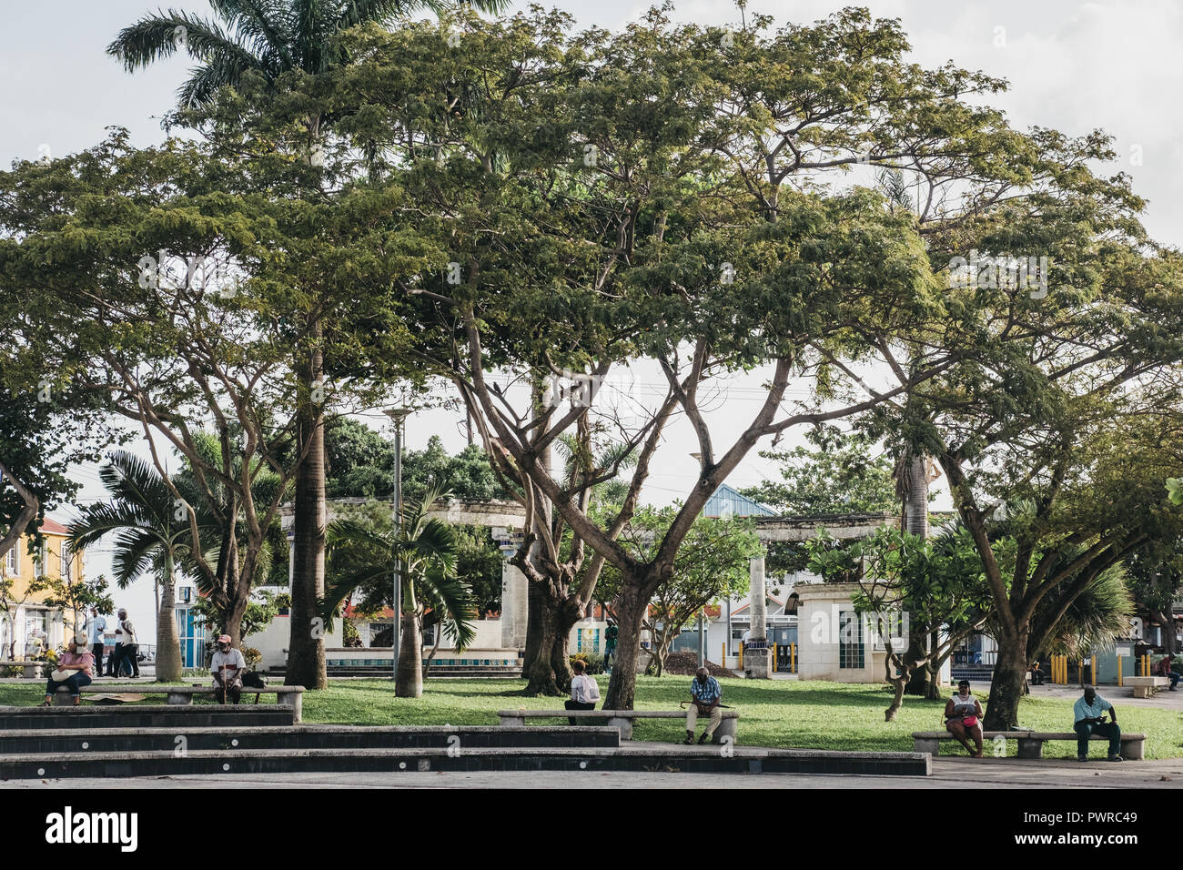 Bridgetown, Barbados - June 26, 2018: People sitting on the benches in ...
