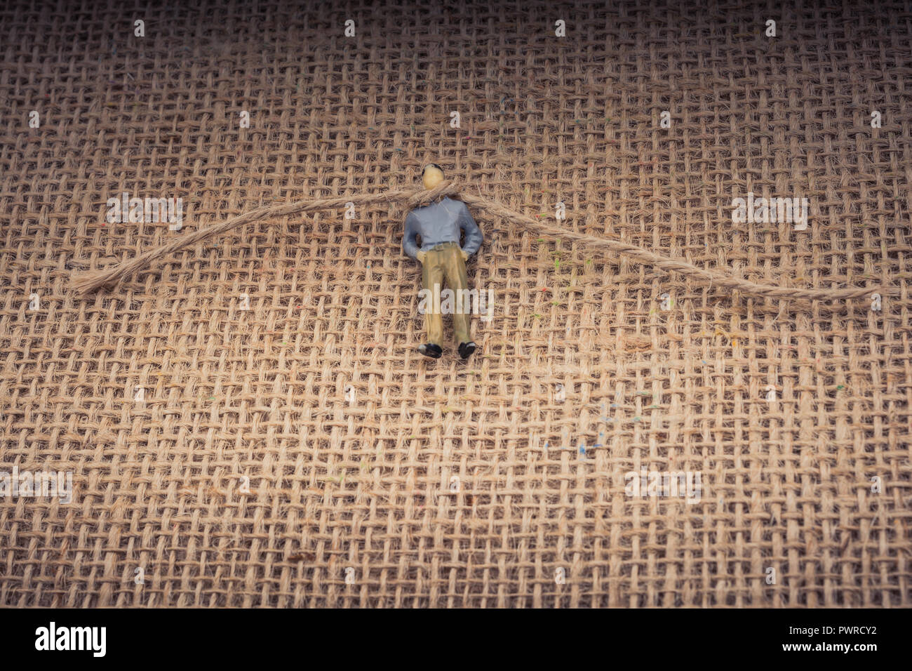 Figurine man with a rope on the neck Stock Photo - Alamy